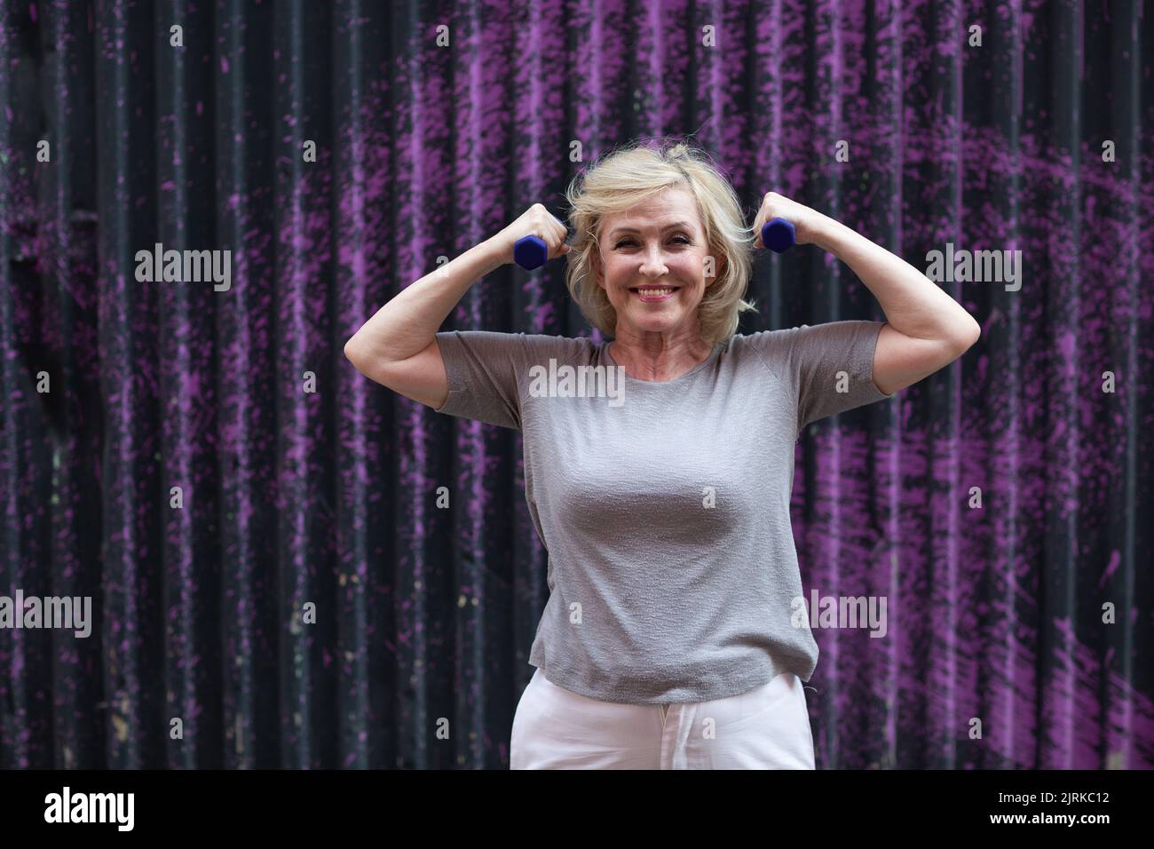 Elderly caucasian old aged woman portrait gray haired doing exercises ...