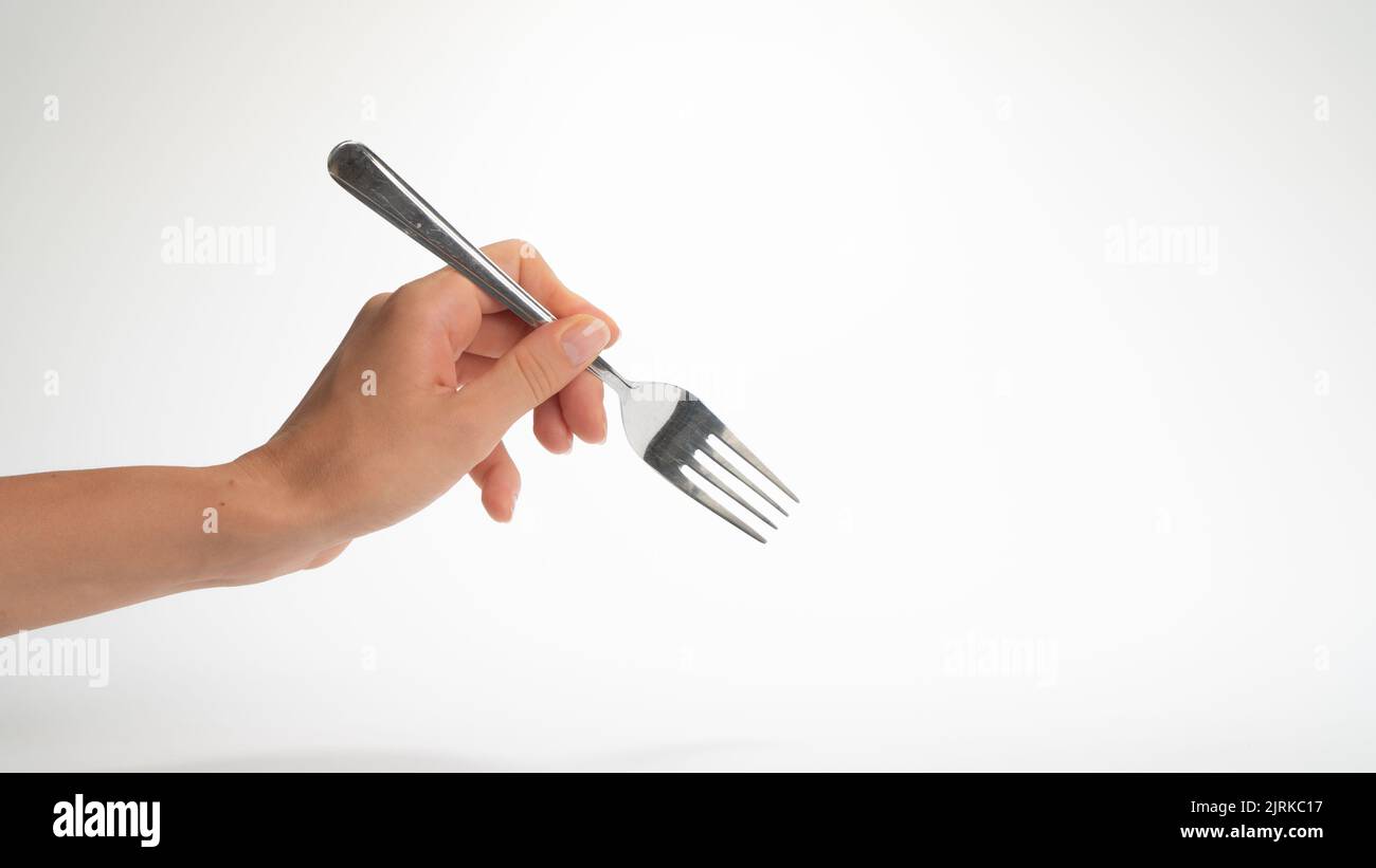 Fork in maiden hand woman gesture to eat on white background. High ...