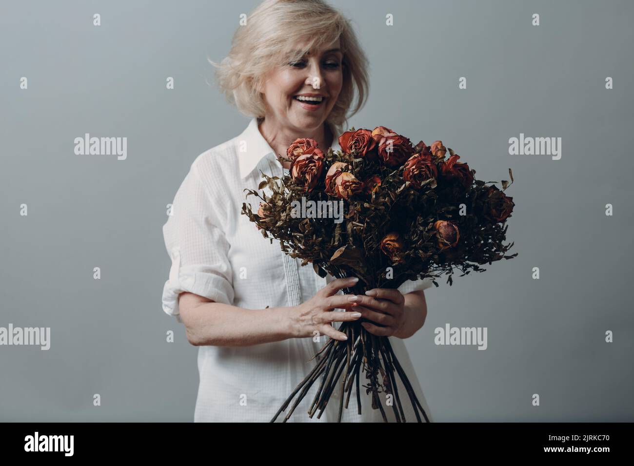 Mature woman roses smile hi-res stock photography and images - Alamy