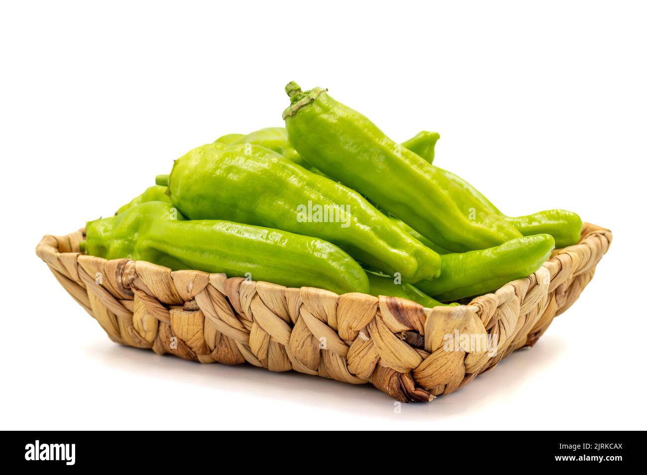 Sweet green peppers. Green pepper in basket isolated on white ...