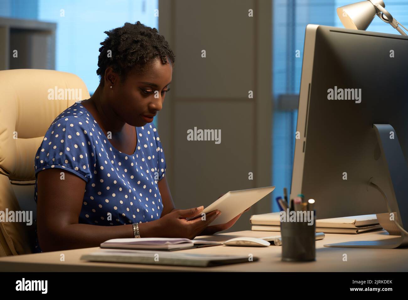 African-American business woman reading information in table computer ...
