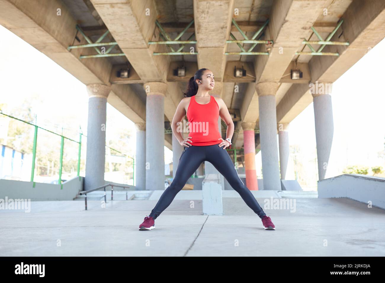 Low angle full body of focused Hispanic sportswoman in activewear and ...