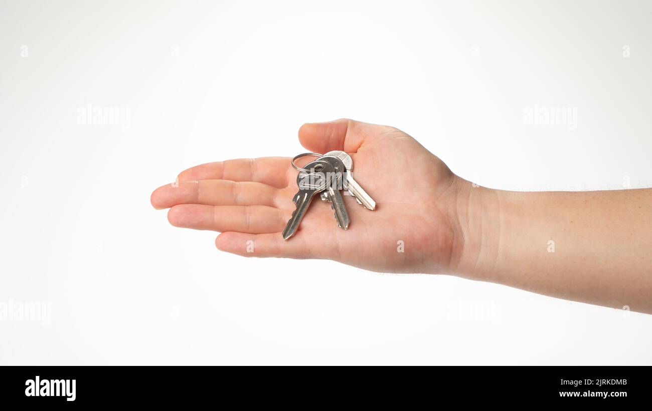 A bunch of keys lies on a man's right palm gesture Stock Photo - Alamy