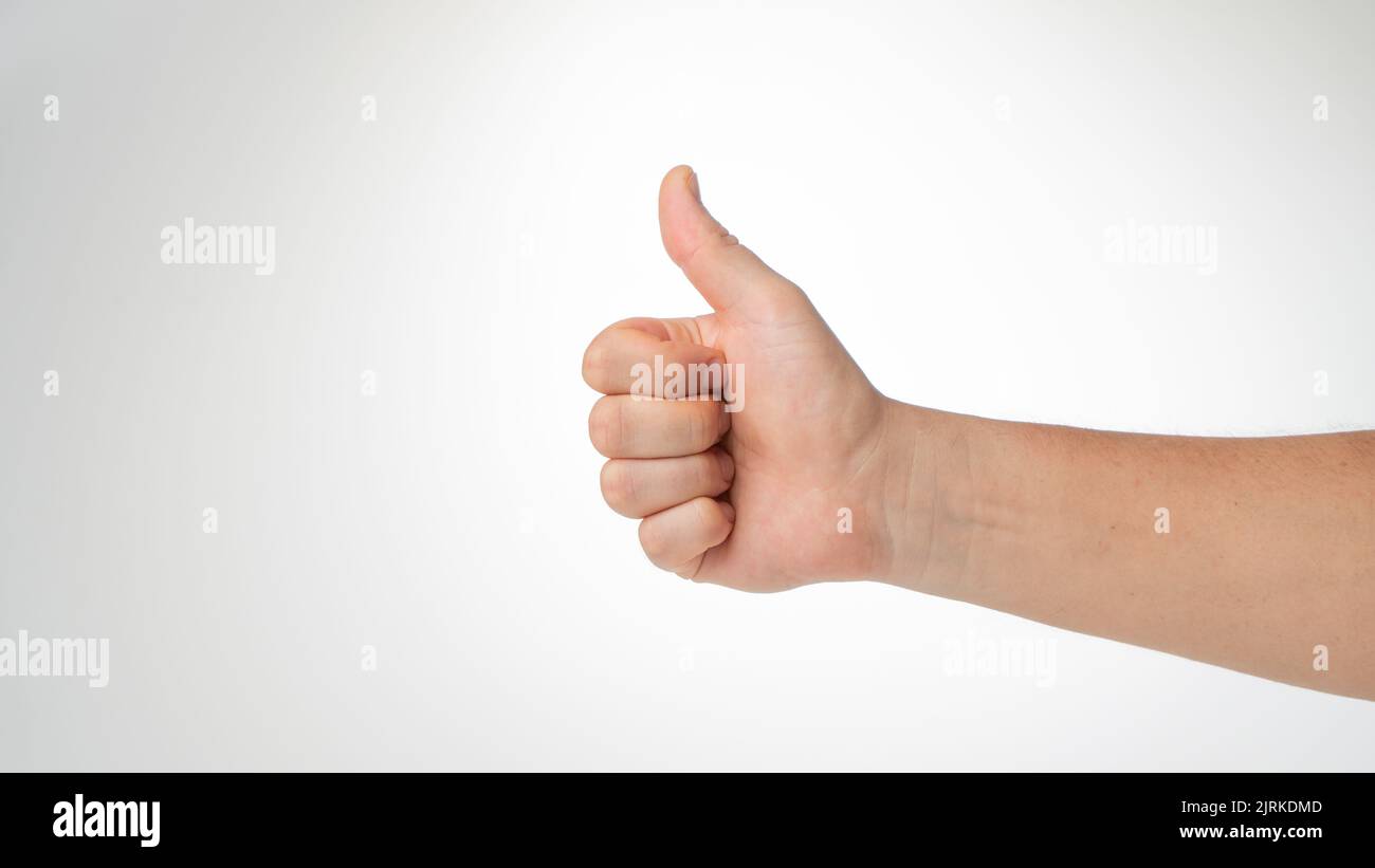 Men's hand thumbs up gesture like, cool Stock Photo - Alamy