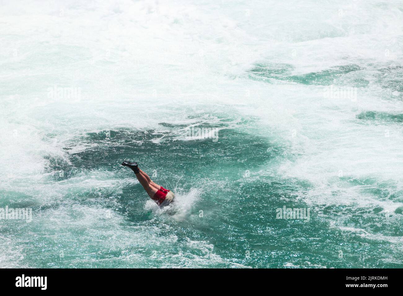 waterfall extreme brave man as superhero running jump and dive from the ...
