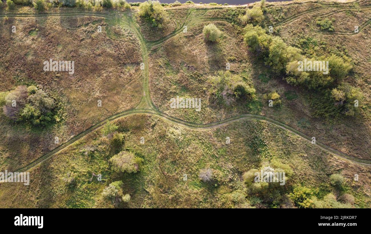 View of the land with bushes, trees and grass in autumn from a ...