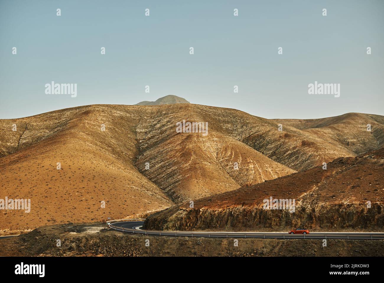 Picturesque panoramic view of mounts against roadway and dry terrain ...