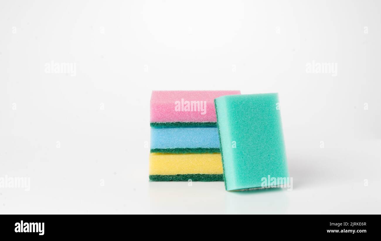 Sponges of different colors are stacked on a white background Stock ...