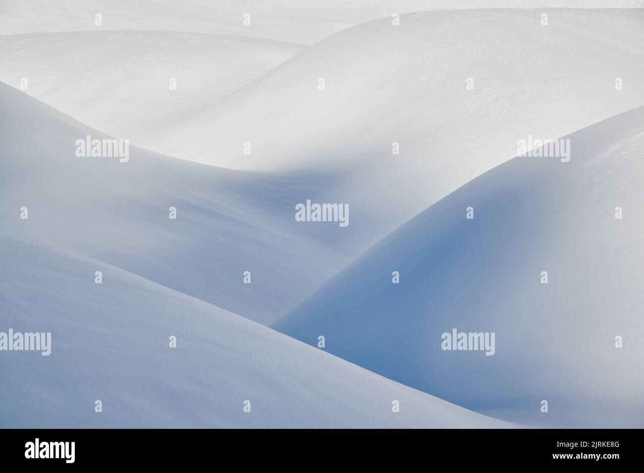 Textured backdrop of snowy terrain with white bumpy surface in winter ...