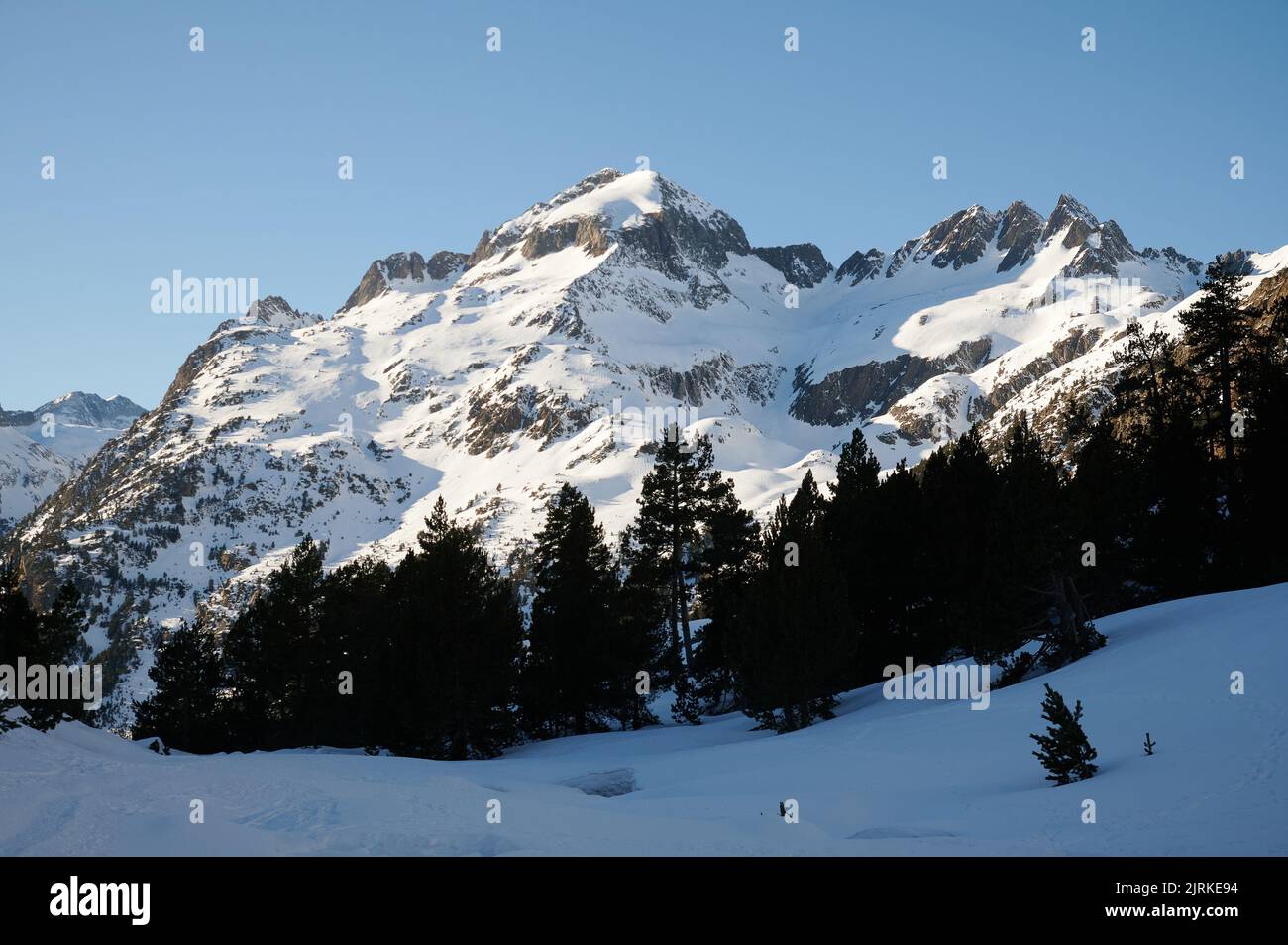 Scenery of high rocky ridge of Pyrenees range covered with snow ...