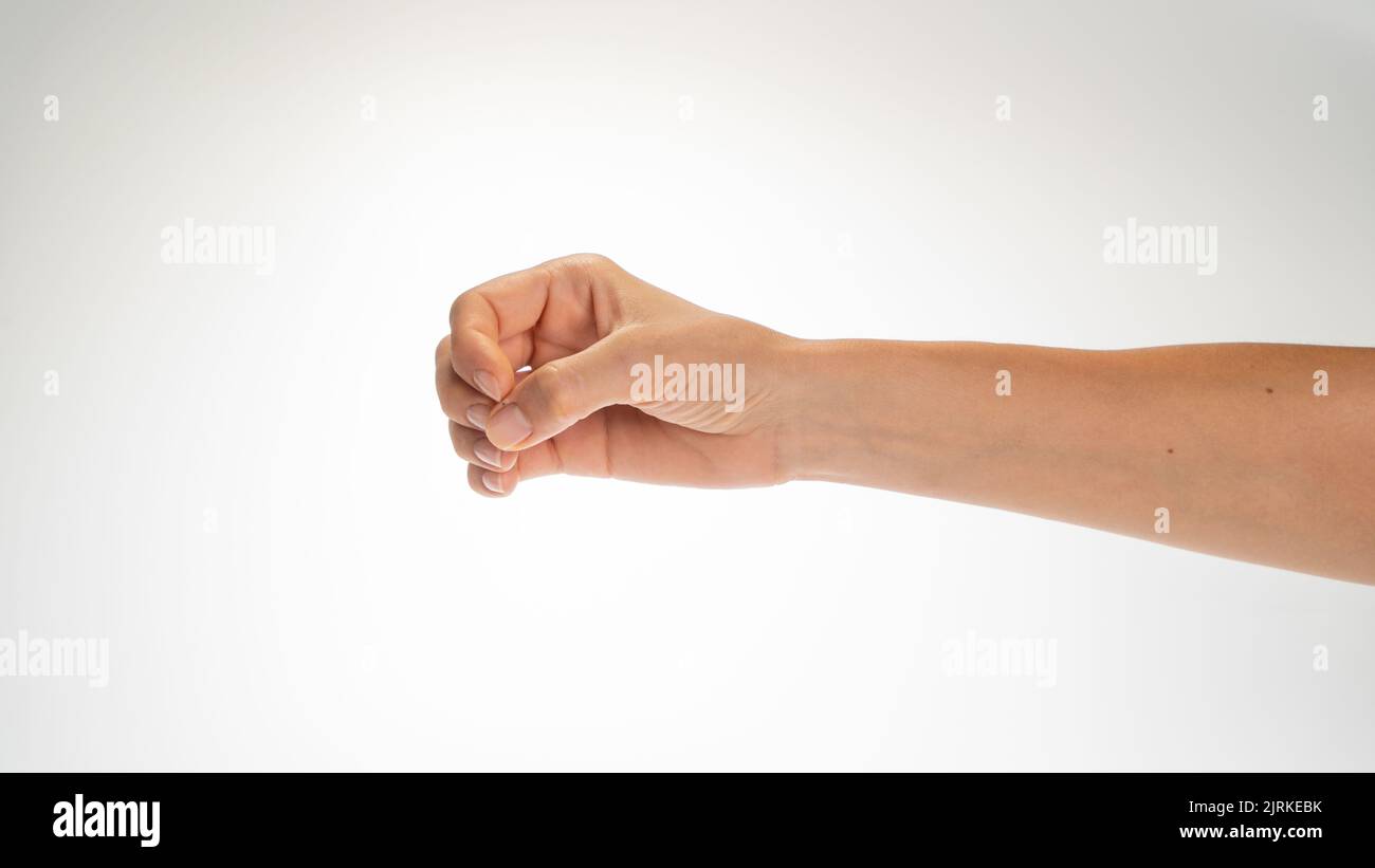 Hand woman gesture fingers clenched into a ring holding a cylindrical ...