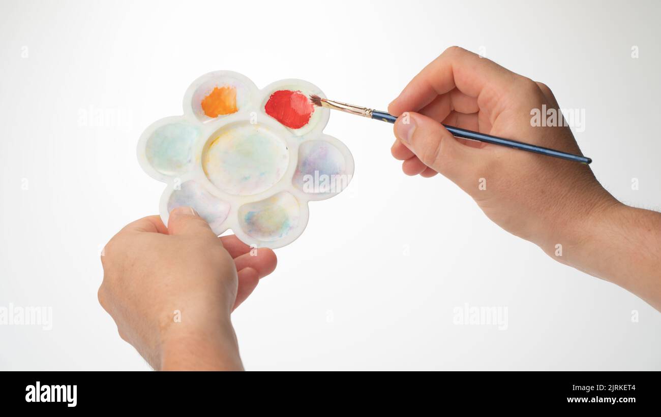 Hands paint brushes palette hi-res stock photography and images - Alamy
