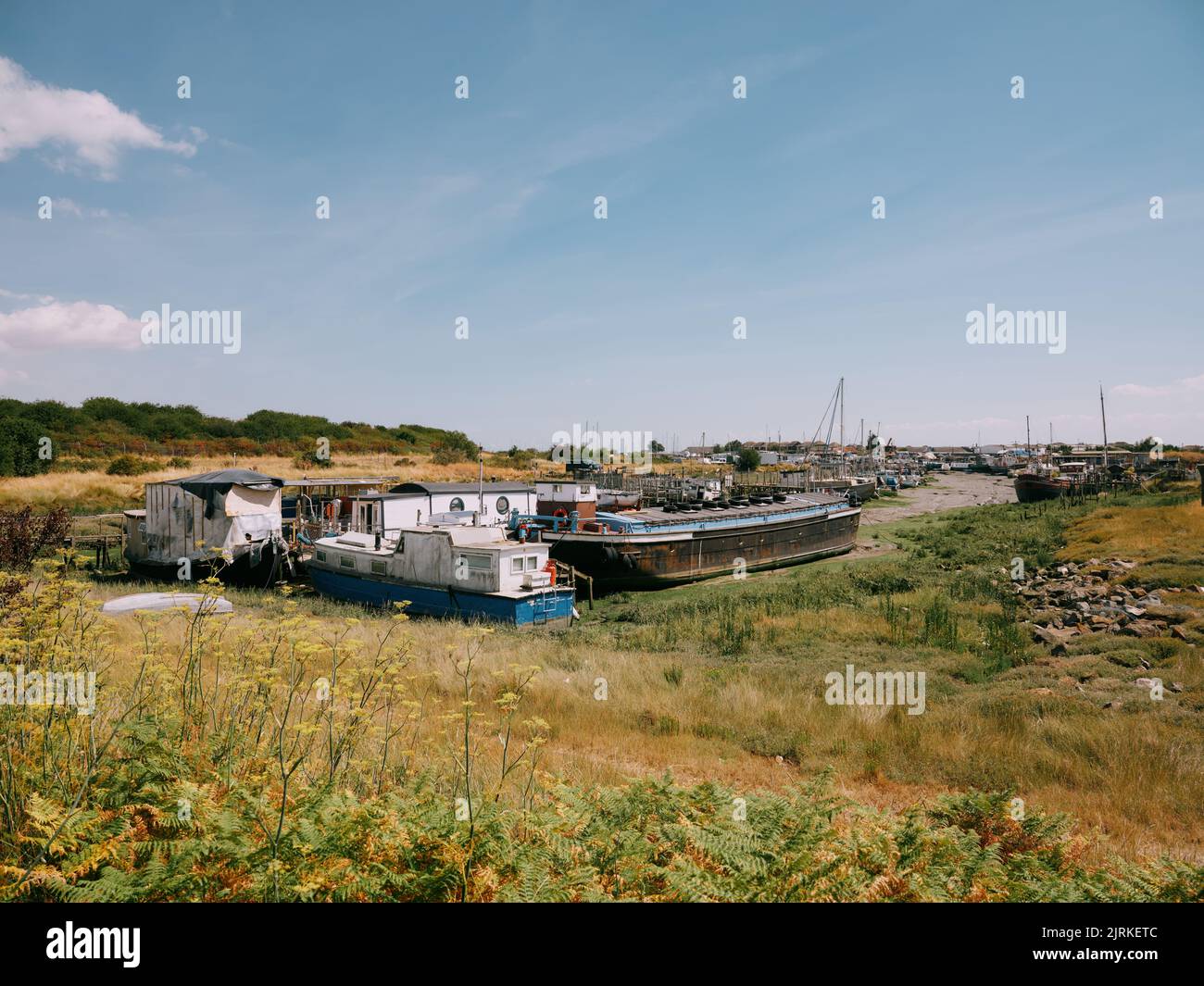 The houseboats at low tide in Oyster Creek in Canvey Island, Thames ...