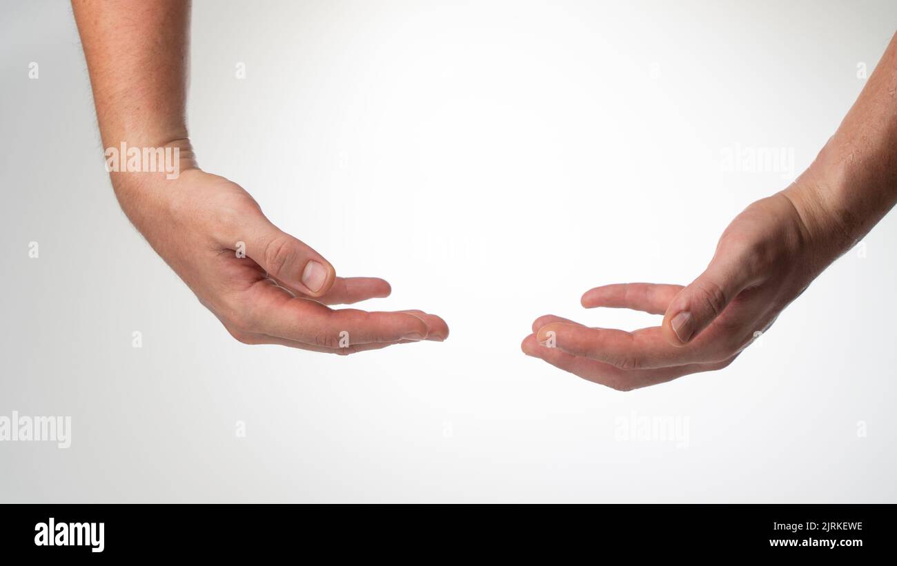 Men's insulated hands hold a heavy object on a white background Stock ...