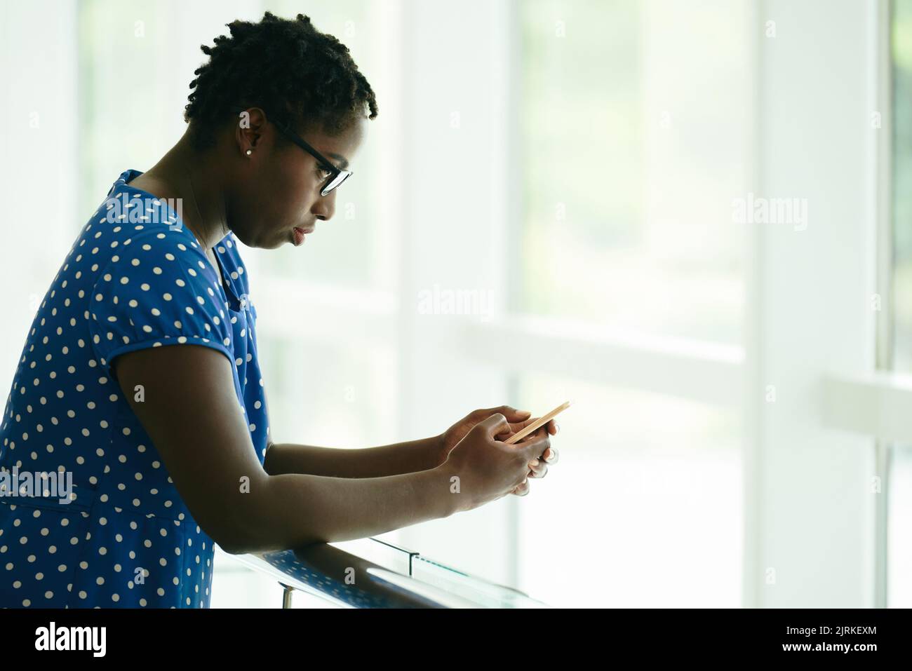 Pretty Black woman texting to friends or business partners Stock Photo ...