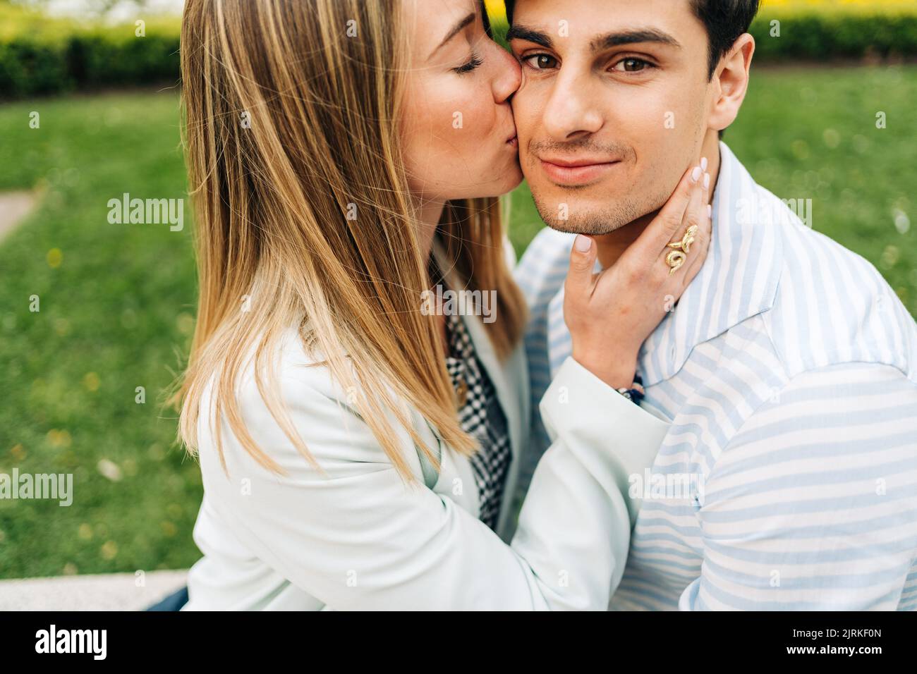 Side view high angle of loving girlfriend gently kissing boyfriend in ...