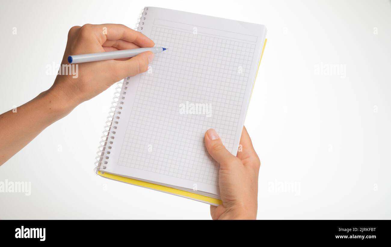 women's hands hold a notebook in a cage left hand with a left-handed ...
