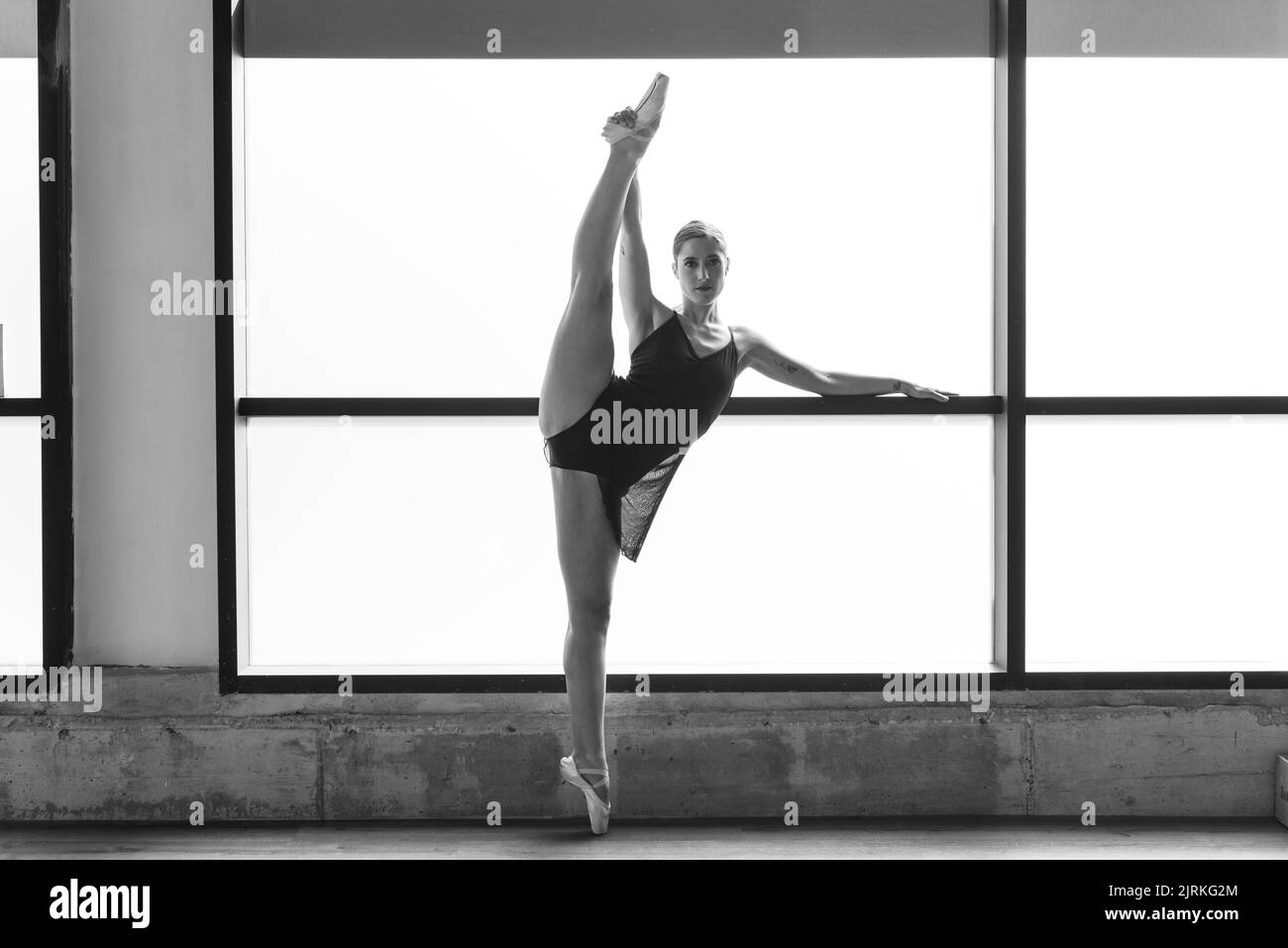 photo of young ballerina posing on tiptoes at dance studio Stock Photo ...