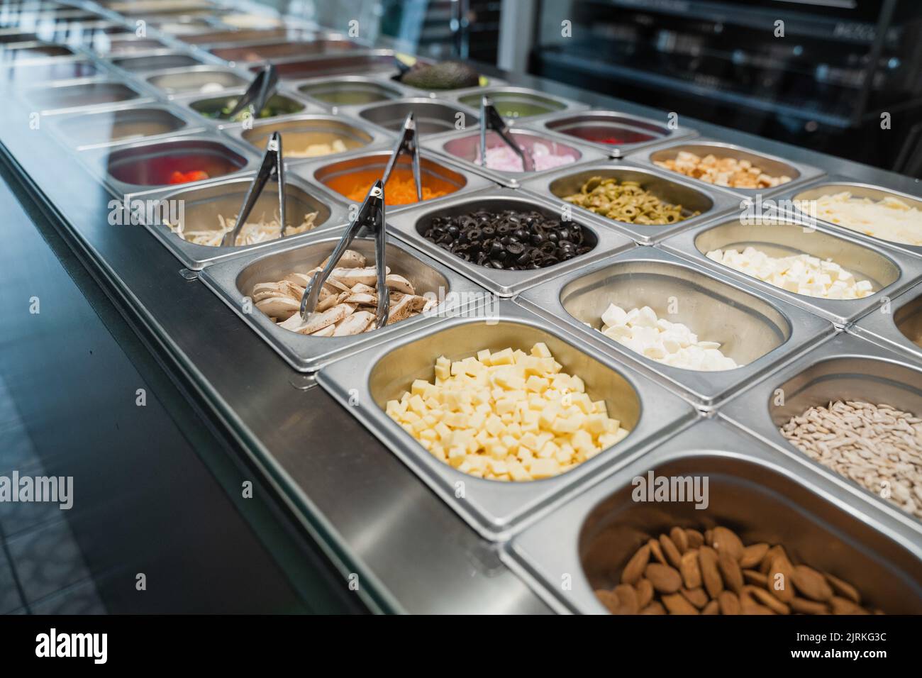 High angle of metal containers with various fresh food located at ...
