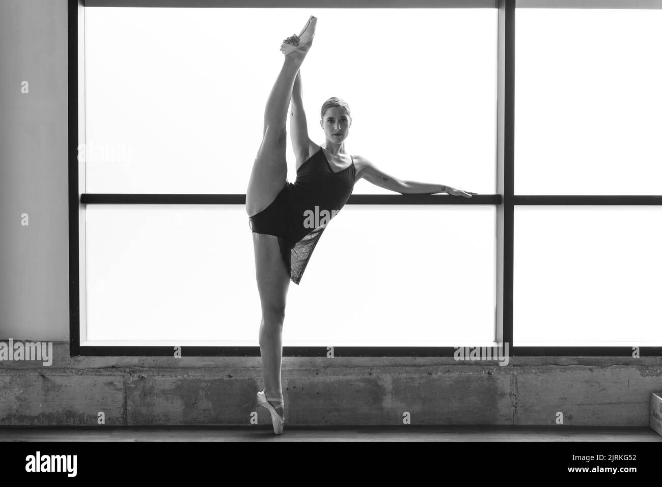 photo of young ballerina posing on tiptoes at dance studio Stock Photo ...