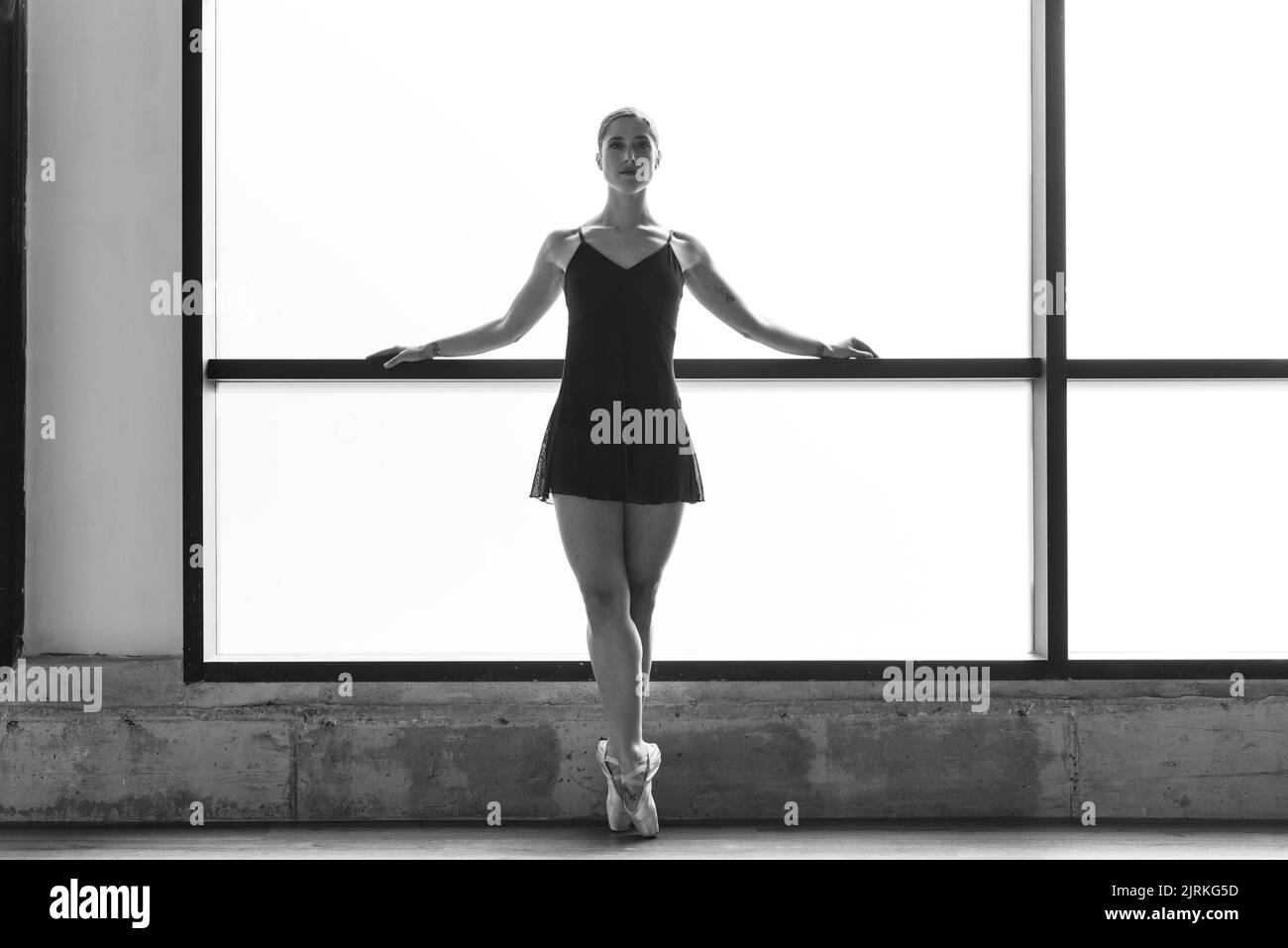 photo of young ballerina posing on tiptoes at dance studio Stock Photo ...