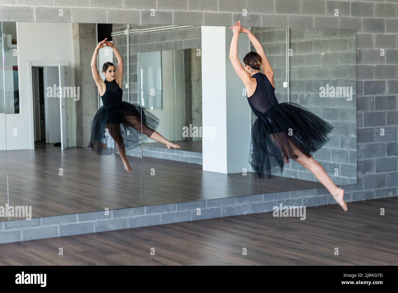 Black and white photo of a young ballerina doing a jumping move in ...