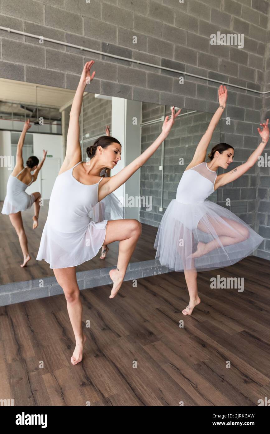 photo of two elegant young ballerinas dancing in synchrony next to a ...