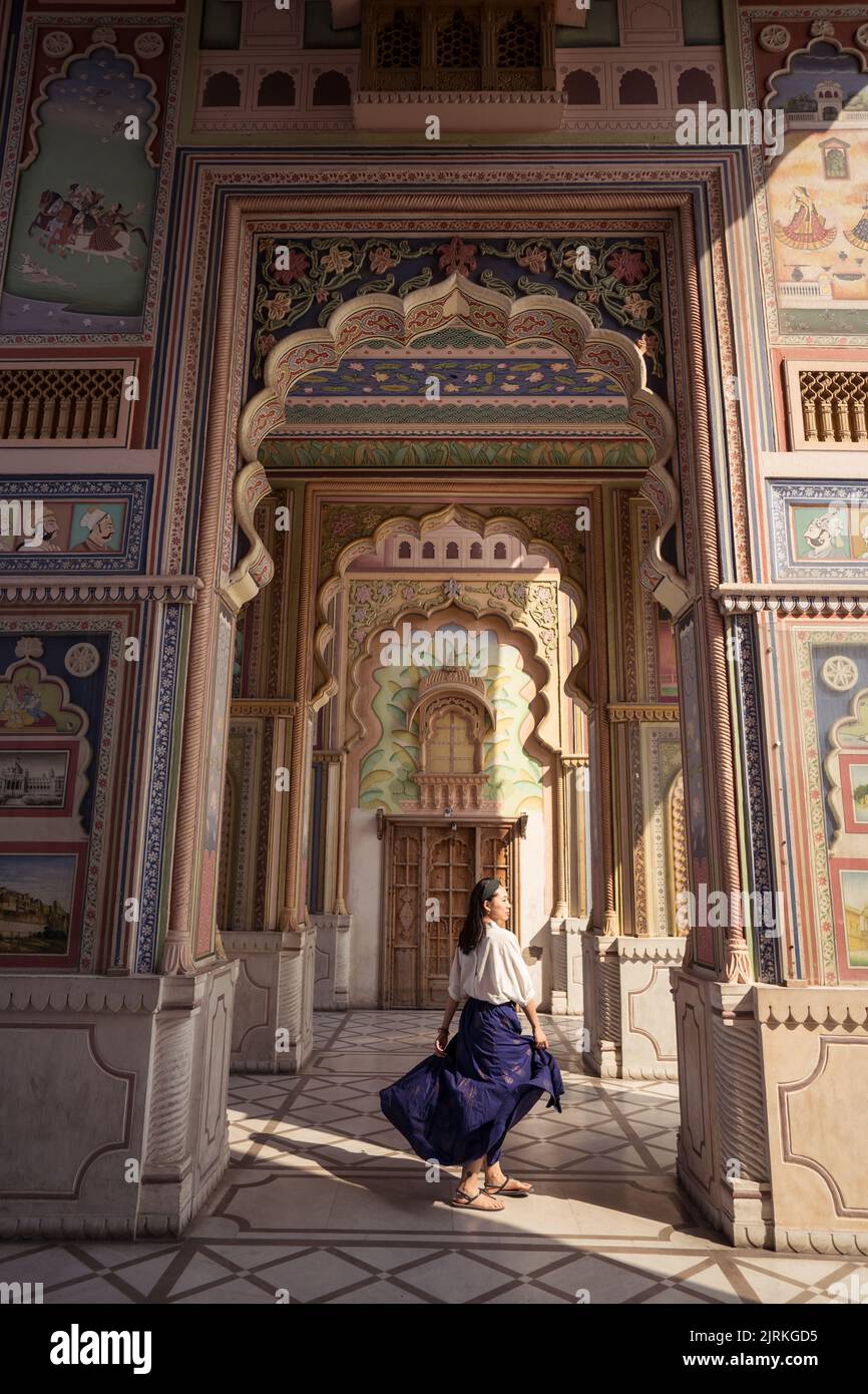 Cheerful ethnic female spinning around and smiling while dancing in ...