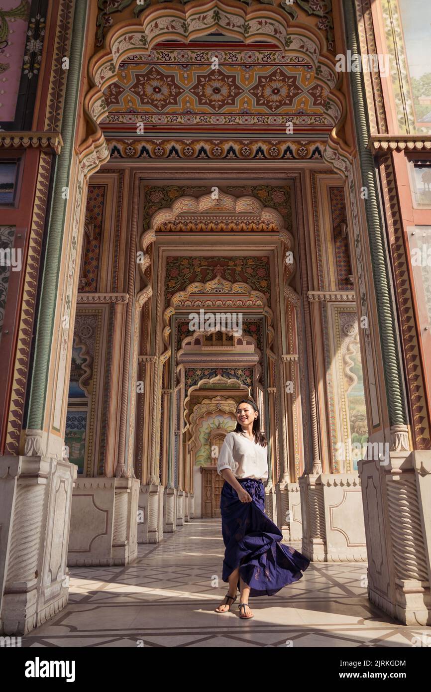 Cheerful ethnic female spinning around and smiling while dancing in ...