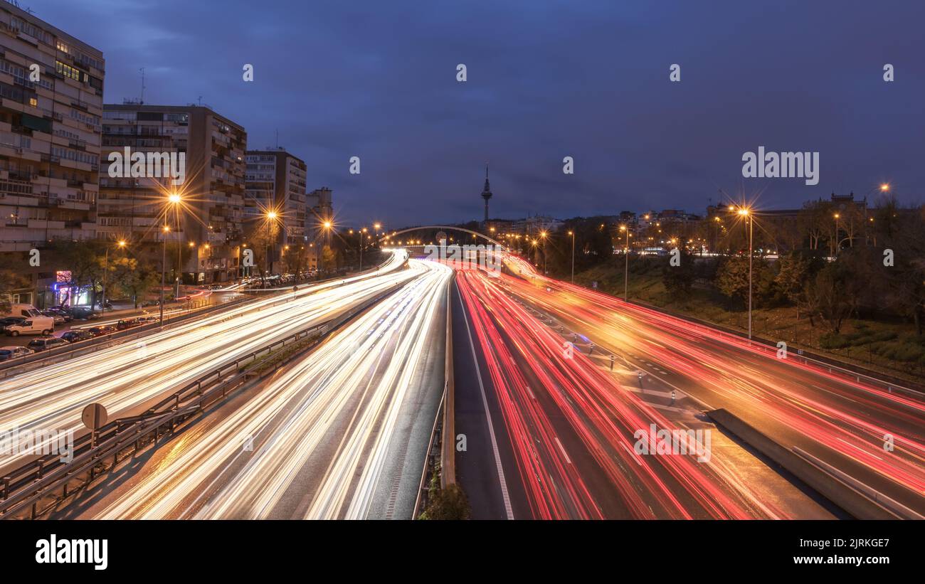 Amazing view of red and white traffic light trails along road in night ...