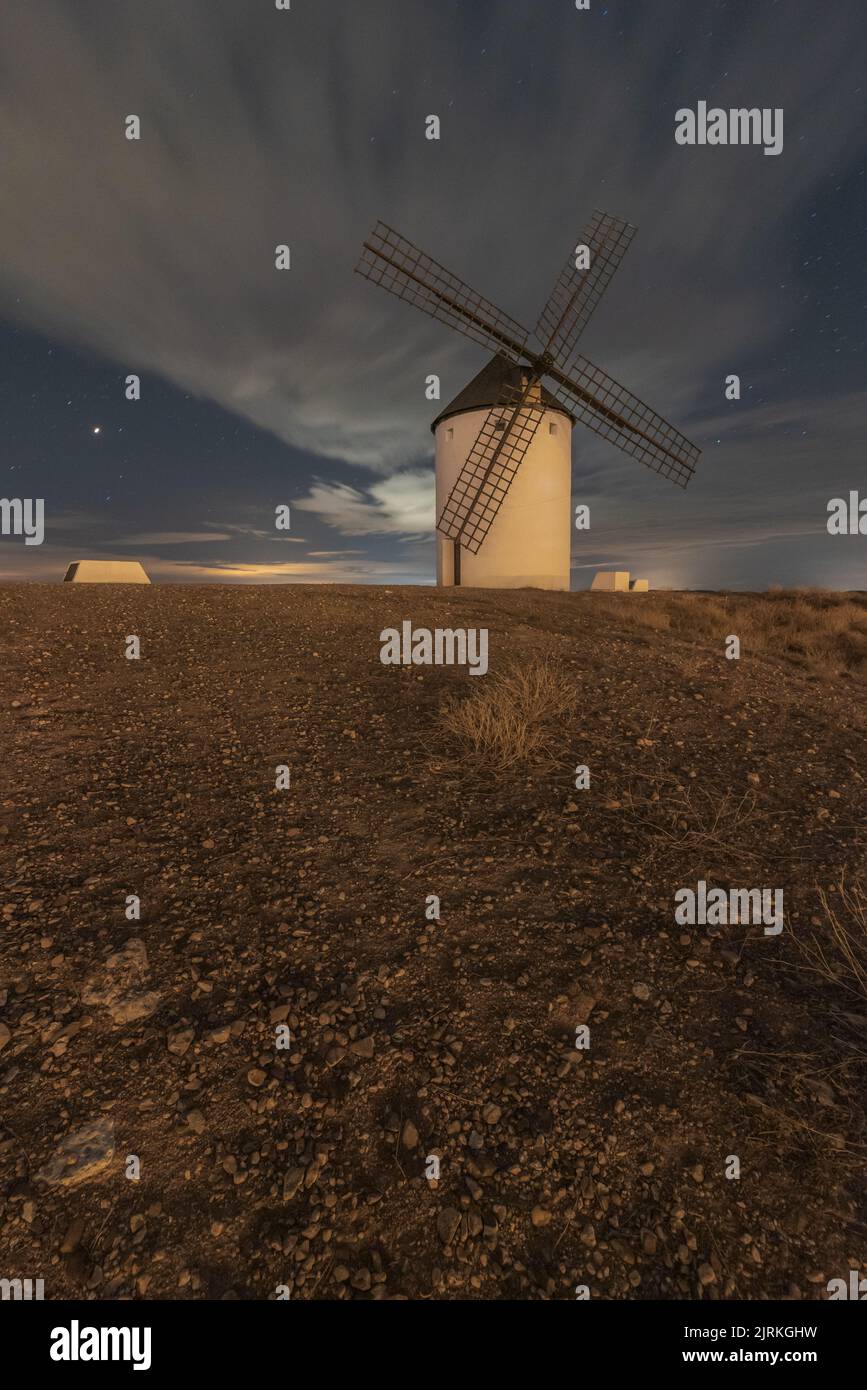 Old traditional windmills located in countryside field on starry night ...