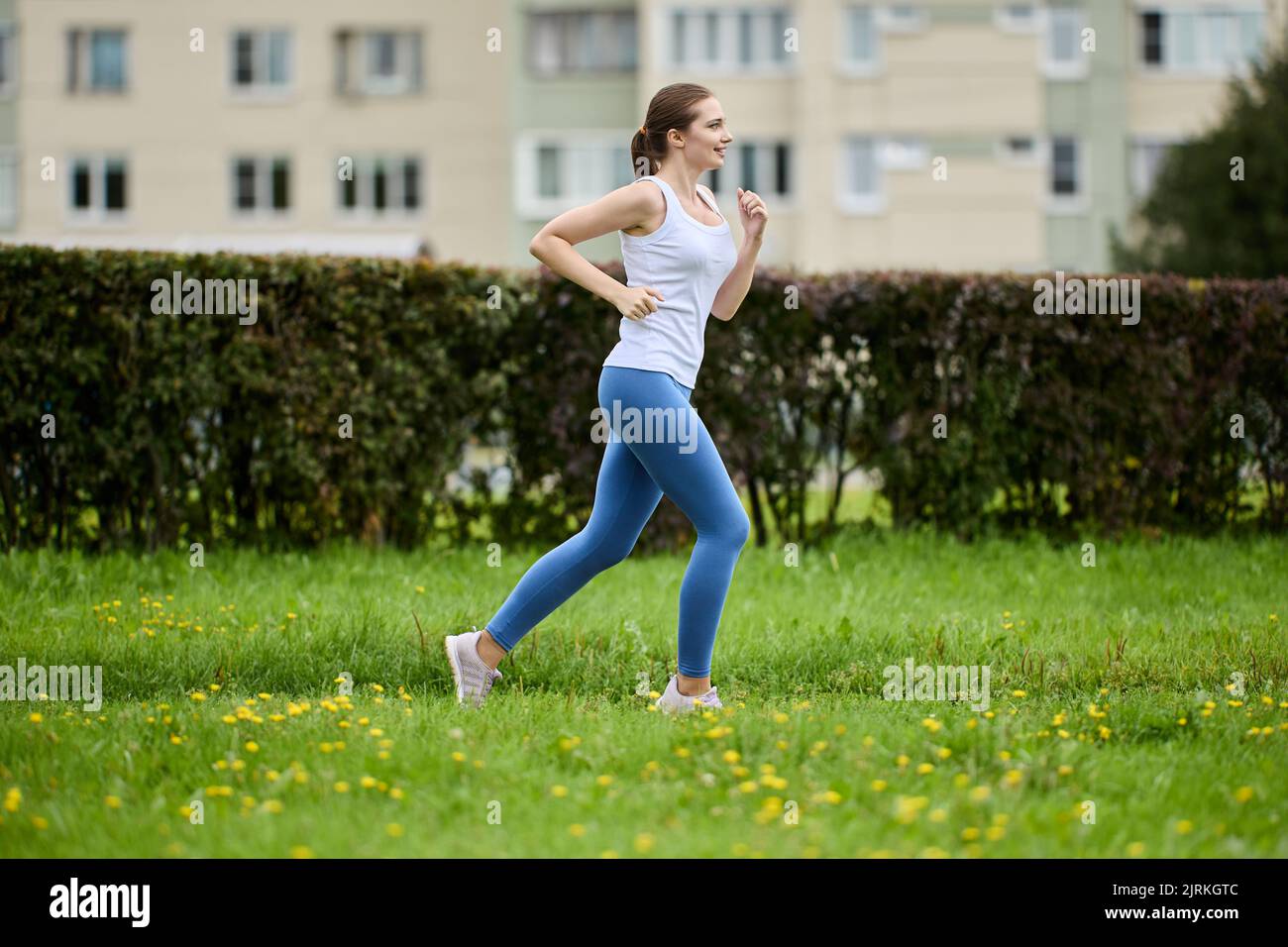 Woman leads healthy lifestyle and takes daily jog in public park in ...