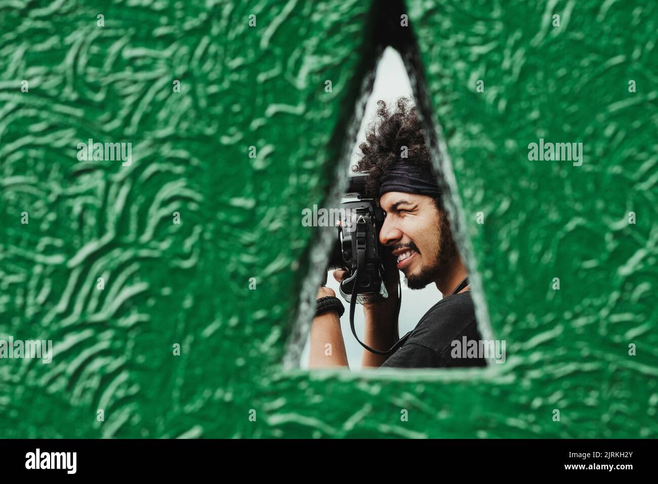 Through triangle shaped hole side view of crop African American man ...