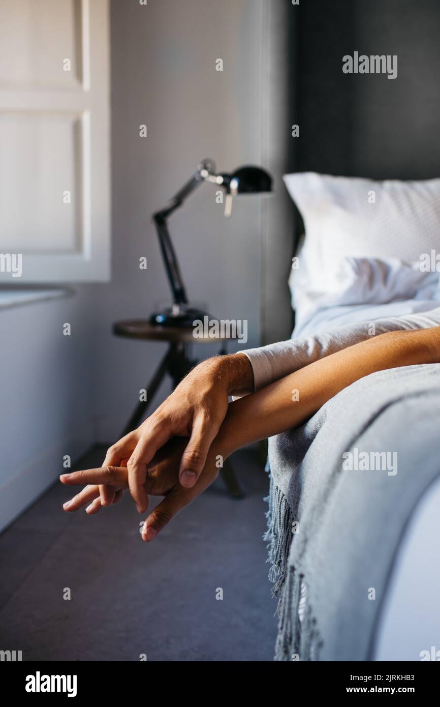 Crop anonymous girlfriend and boyfriend twisting fingers while holding ...