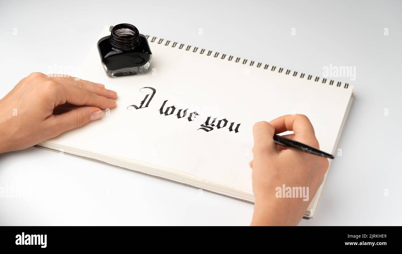 Women's hands write I love you fountain pen for calligraphy Stock Photo ...