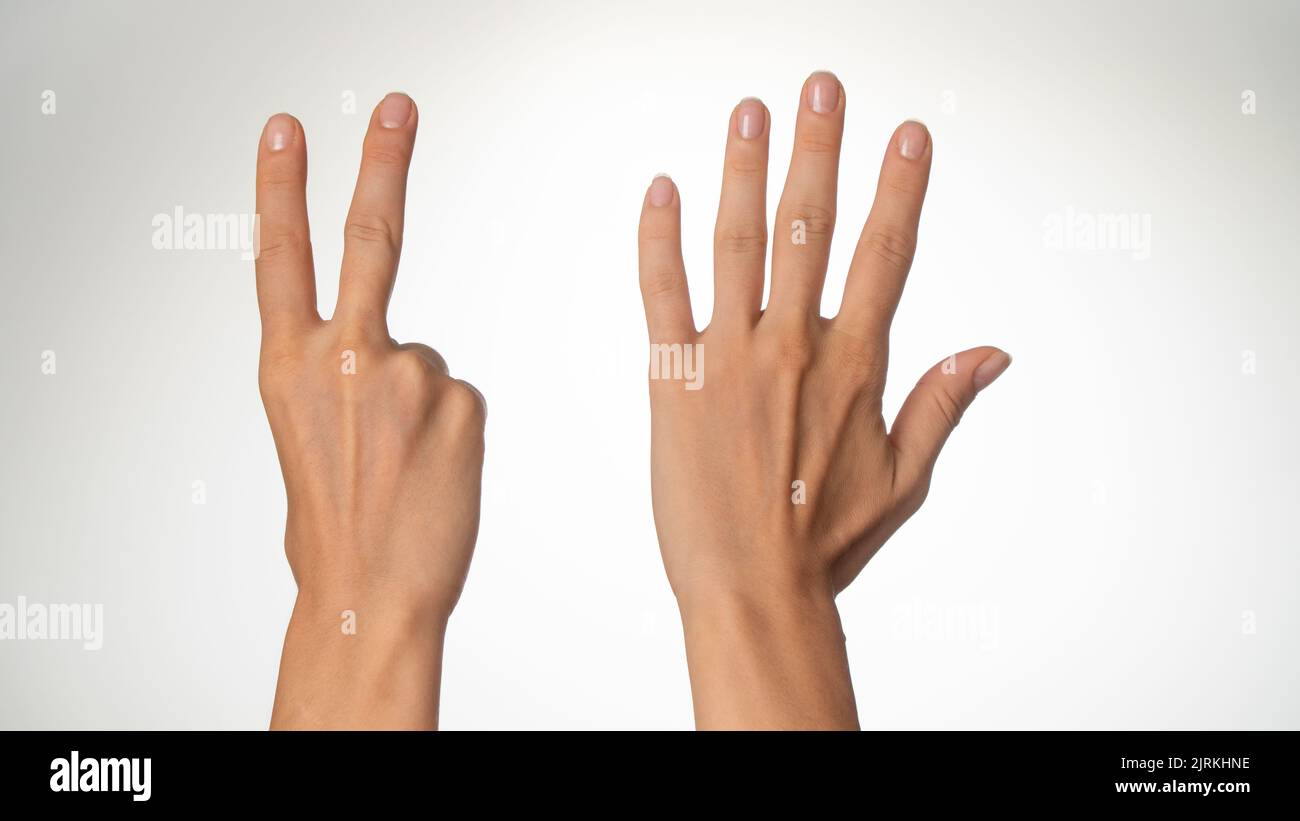 Women's hands count on fingers seven back of palms Stock Photo - Alamy