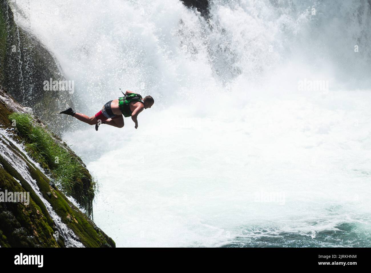 waterfall extreme brave man as superhero running jump and dive from the ...