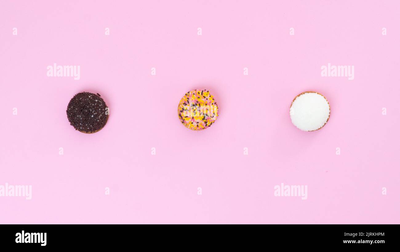 Three cakes on a pink background Stock Photo - Alamy