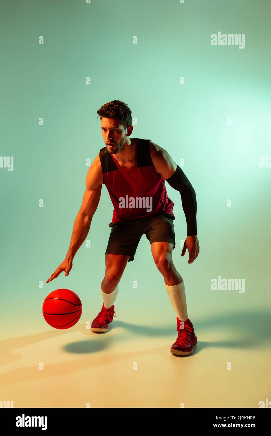 Creative studio shot of basketball player in the studio using color ...