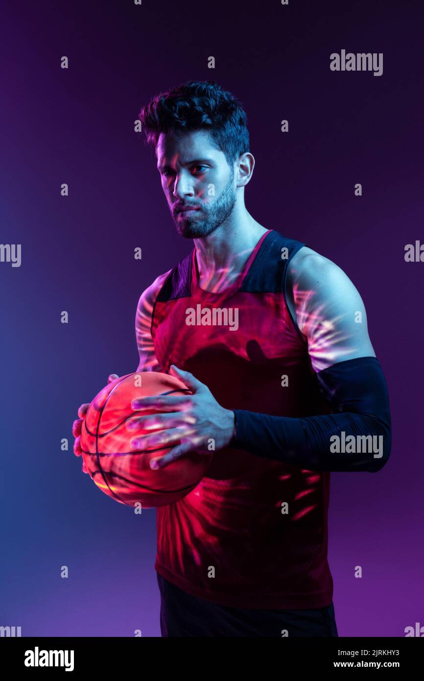 Creative studio shot of basketball player in the studio using color ...