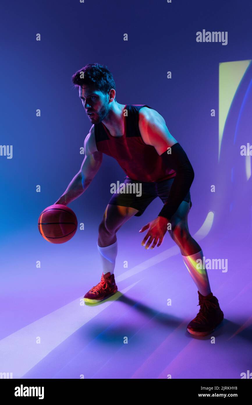 Creative studio shot of basketball player in the studio using color ...
