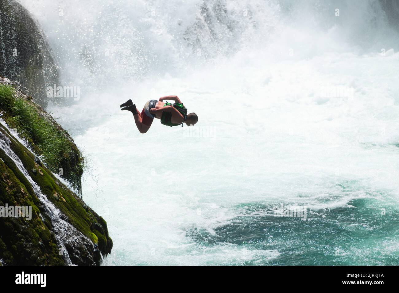 waterfall extreme brave man as superhero running jump and dive from the ...