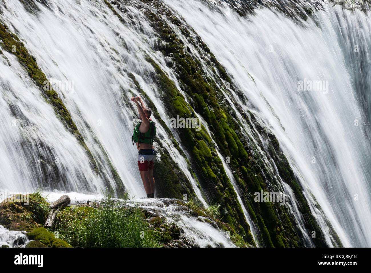 waterfall extreme brave man as superhero running jump and dive from the ...