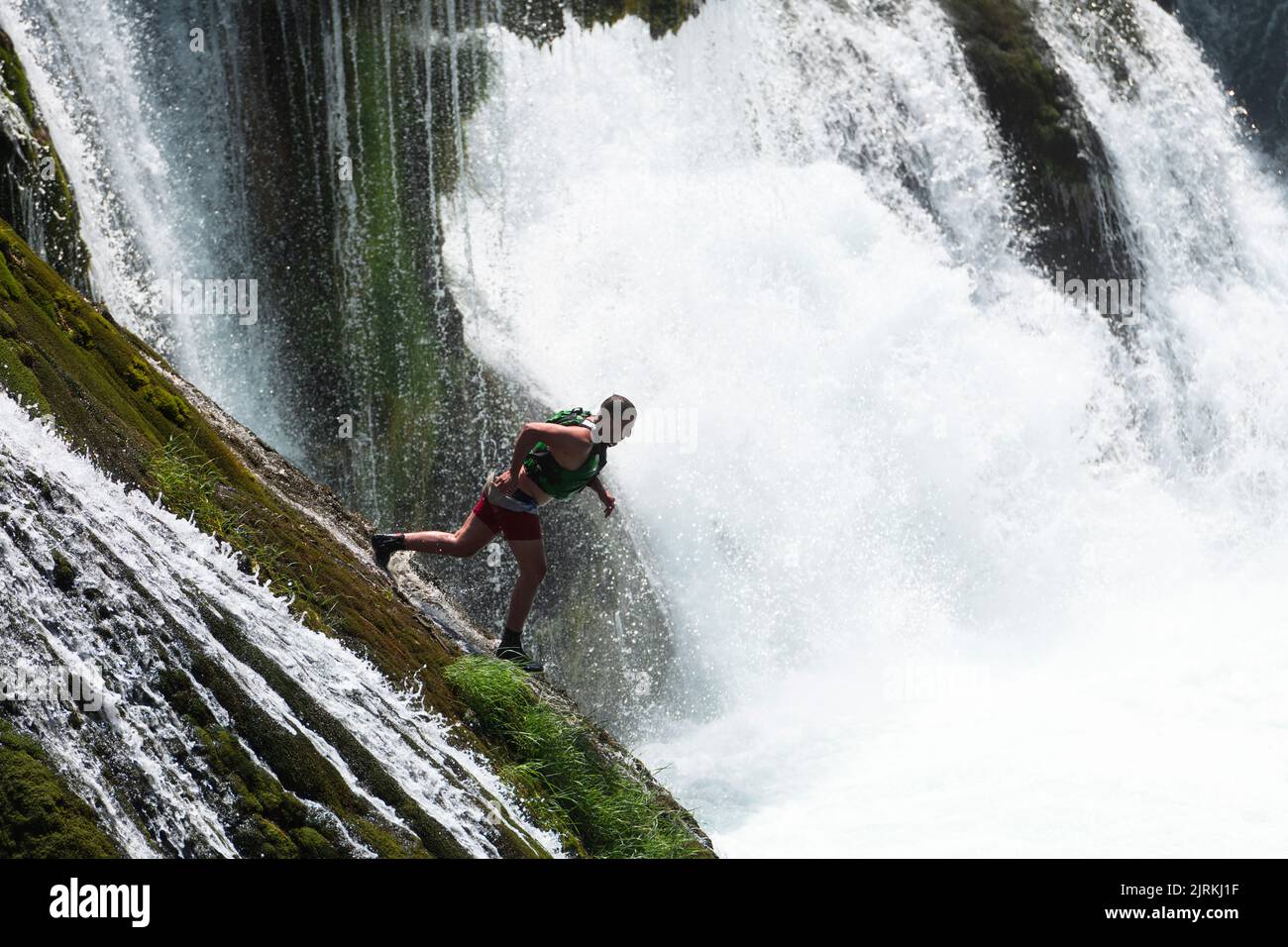 waterfall extreme brave man as superhero running jump and dive from the ...