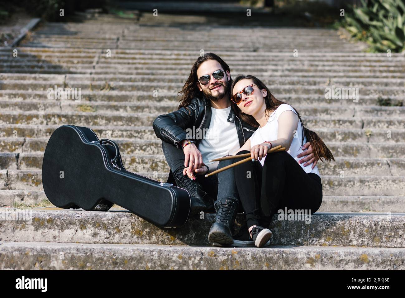 Cheerful bearded Latin American man embracing charming girlfriend while ...