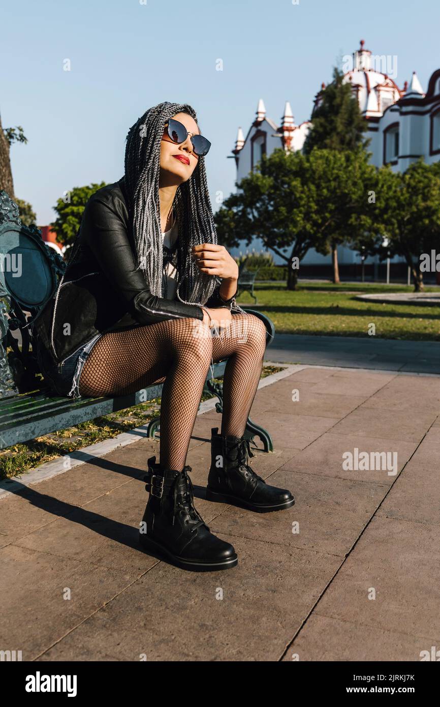 Cool Latin American female with Afro braids in modern sunglasses and ...