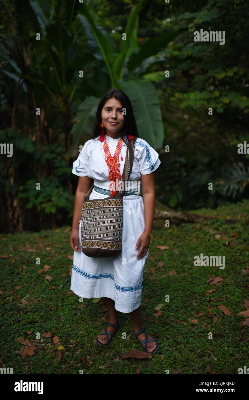 Full body portrait of happy young Arhuaco indigenous woman in a forest ...