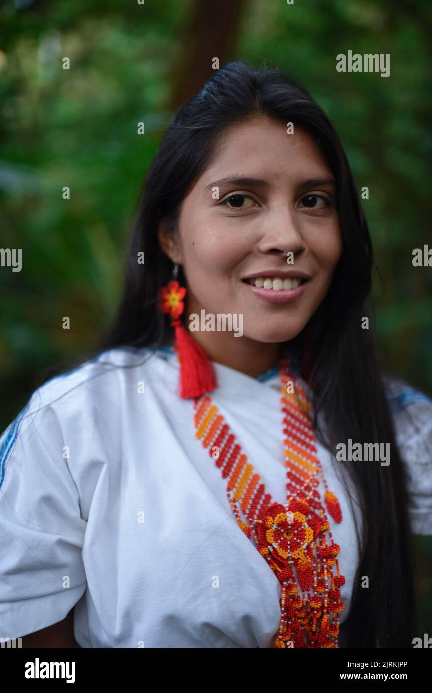 Close up portrait of happy young Arhuaco indigenous woman in a forest ...