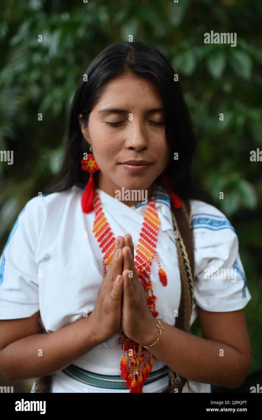 Close up portrait of young Arhuaco indigenous woman with eyes closed in ...