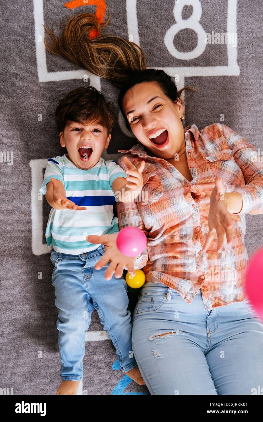 From above delighted woman and little boy screaming and throwing ...